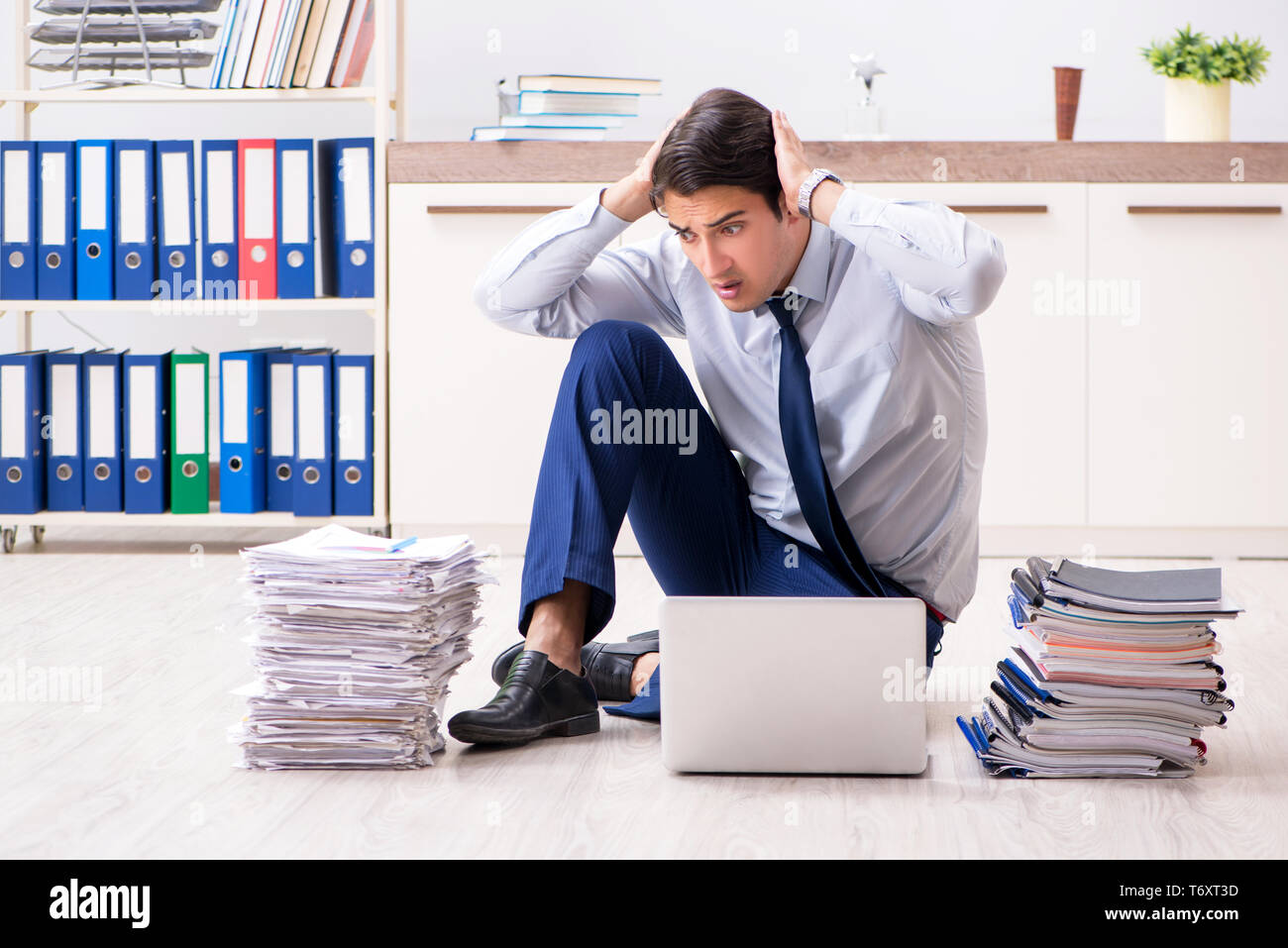 Extremely busy employee working in the office Stock Photo - Alamy