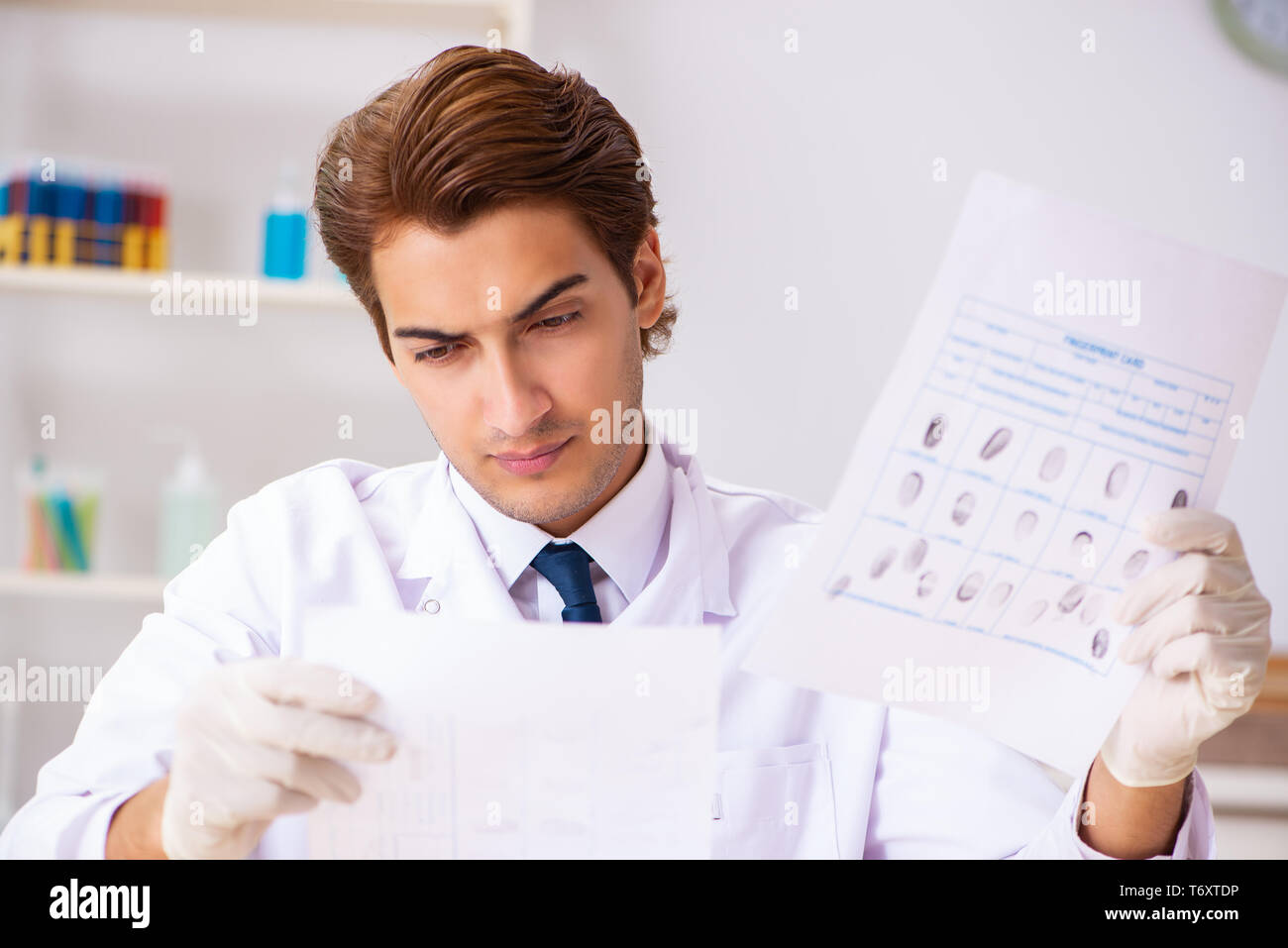 Forensic expert studying fingerprints hi-res stock photography and ...