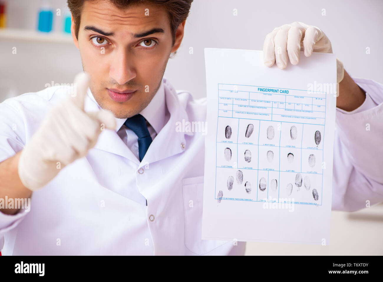Forensic expert studying fingerprints hi-res stock photography and images - Alamy