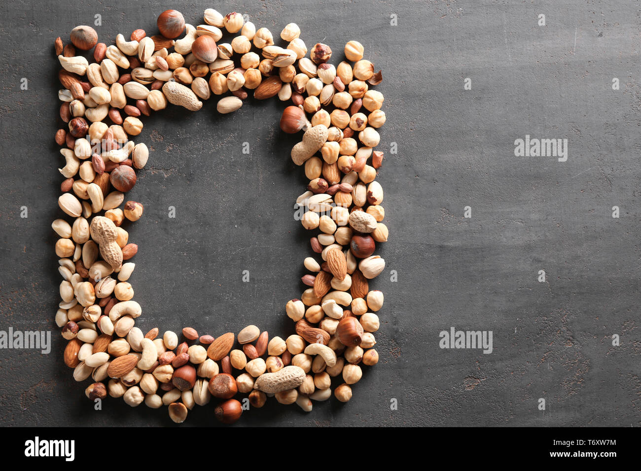 Frame made of different nuts on grey background Stock Photo - Alamy