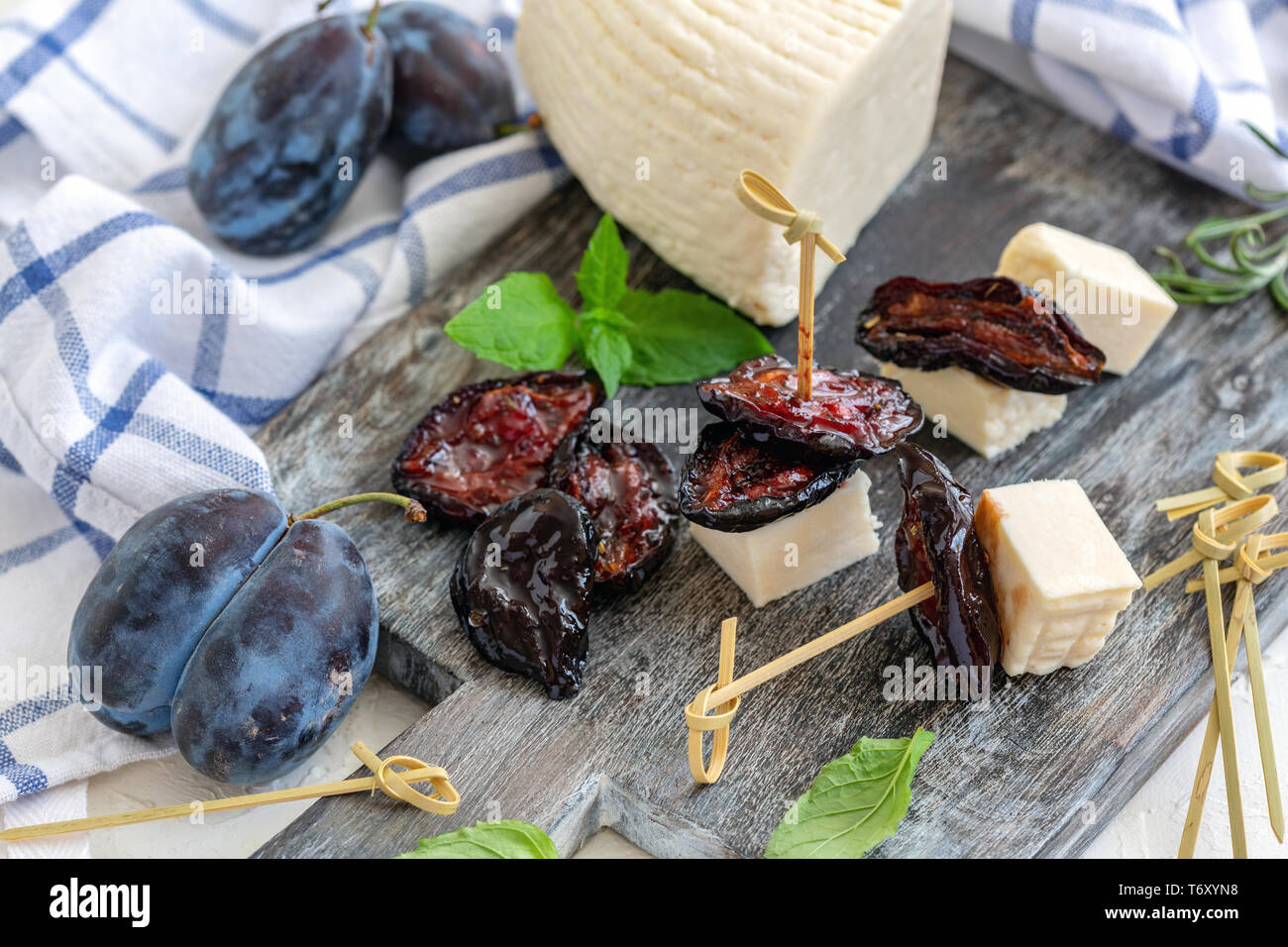 Dried spicy plums and artisanal soft cheese Stock Photo - Alamy