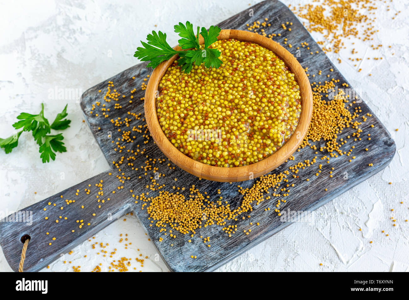 Bowl with grain mustard and yellow mustard seeds Stock Photo - Alamy