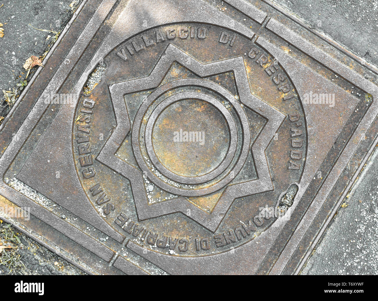 Manhole cover with the Crespi family logo Stock Photo - Alamy