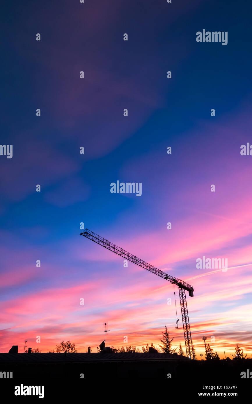 Construction crane over sunset sky Stock Photo - Alamy