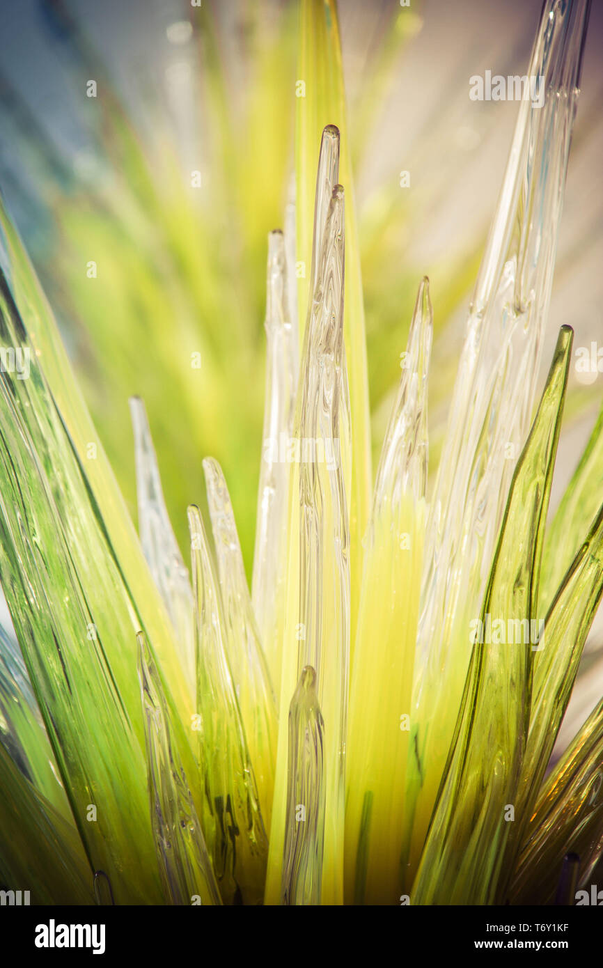 Colorful glass spikes pointing upward from bottom center with blurred ...