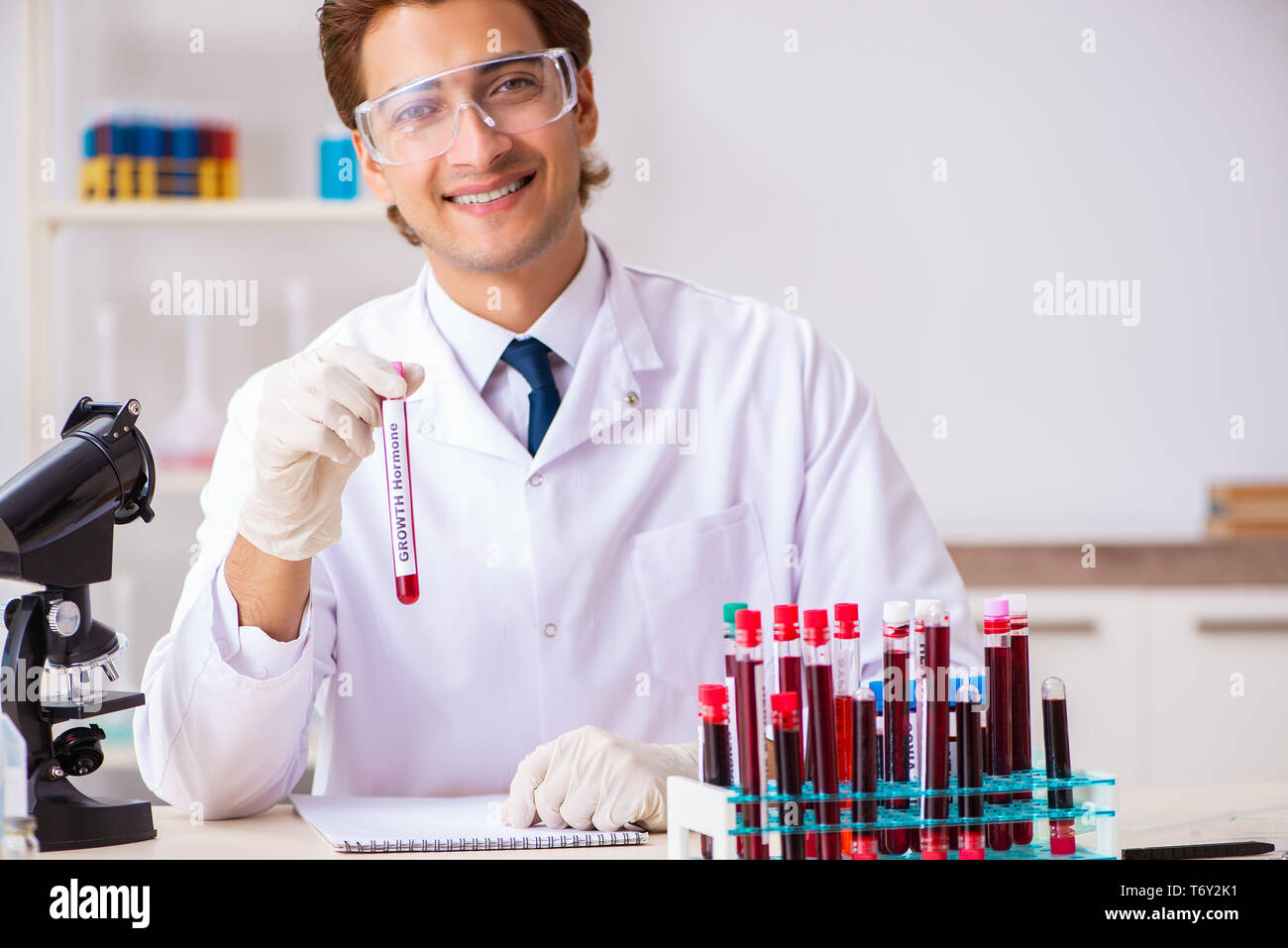 The young handsome lab assistant testing blood samples in hospital ...