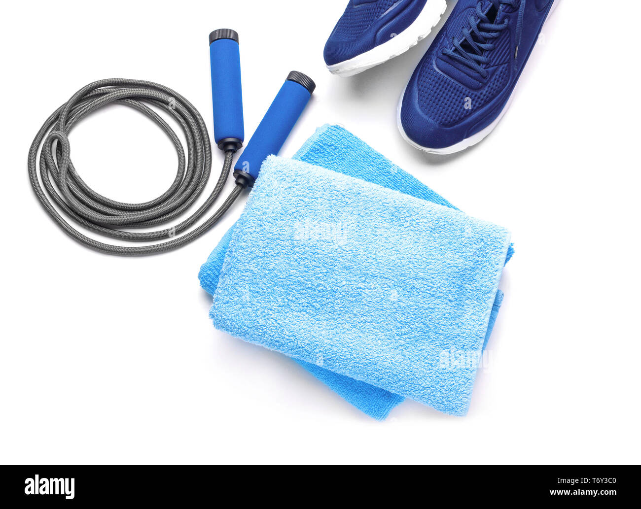 Jump rope, sneakers and clean towel on white background Stock Photo - Alamy