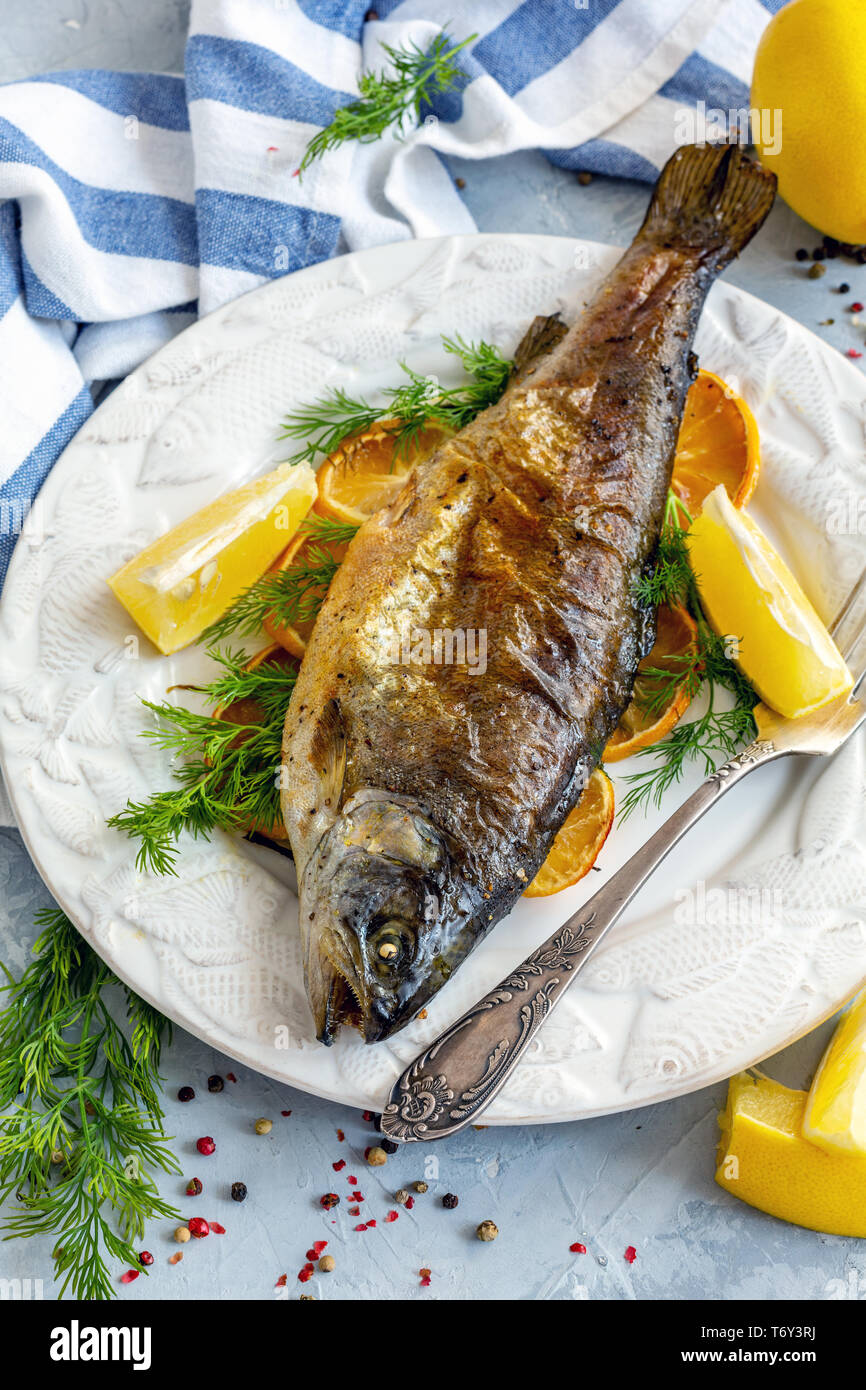 Baked lake trout with lemon and dill Stock Photo - Alamy