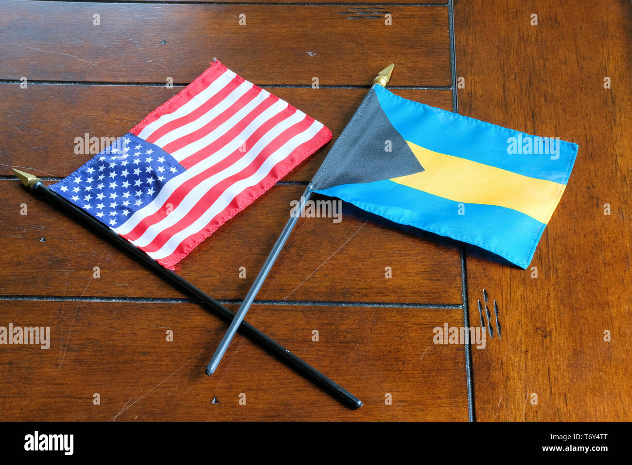 Flags of the United States and the Bahamas on a wooden surface ...