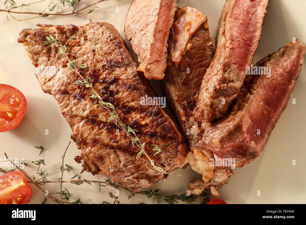 Delicious grilled meat with garnish on light background, closeup Stock ...