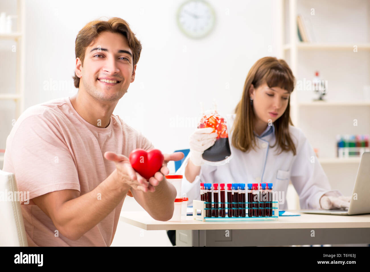 Man giving his blood as a donor Stock Photo - Alamy