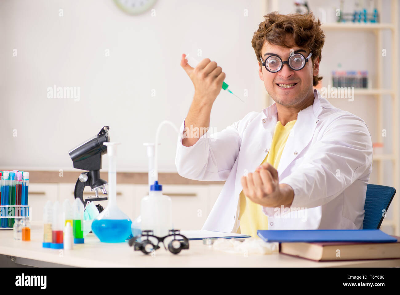 Funny crazy chemist doing experiments and tests Stock Photo - Alamy