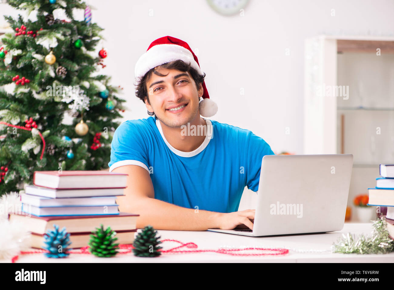 Young student with book at Christmas eve Stock Photo - Alamy