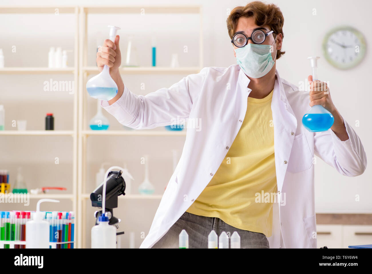 Funny crazy chemist doing experiments and tests Stock Photo - Alamy