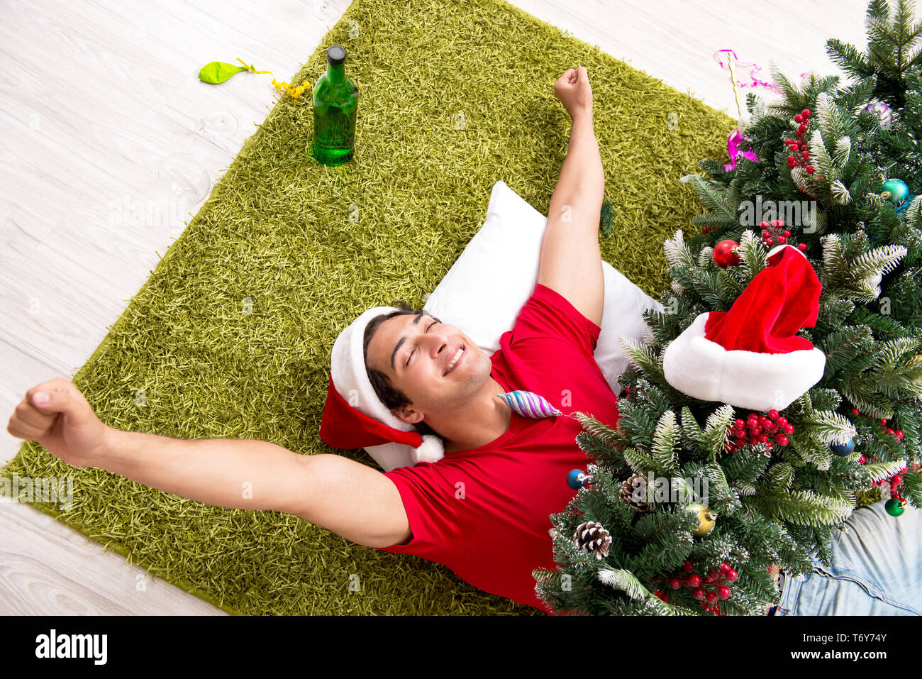 Young man drunk at home after christmas party Stock Photo - Alamy