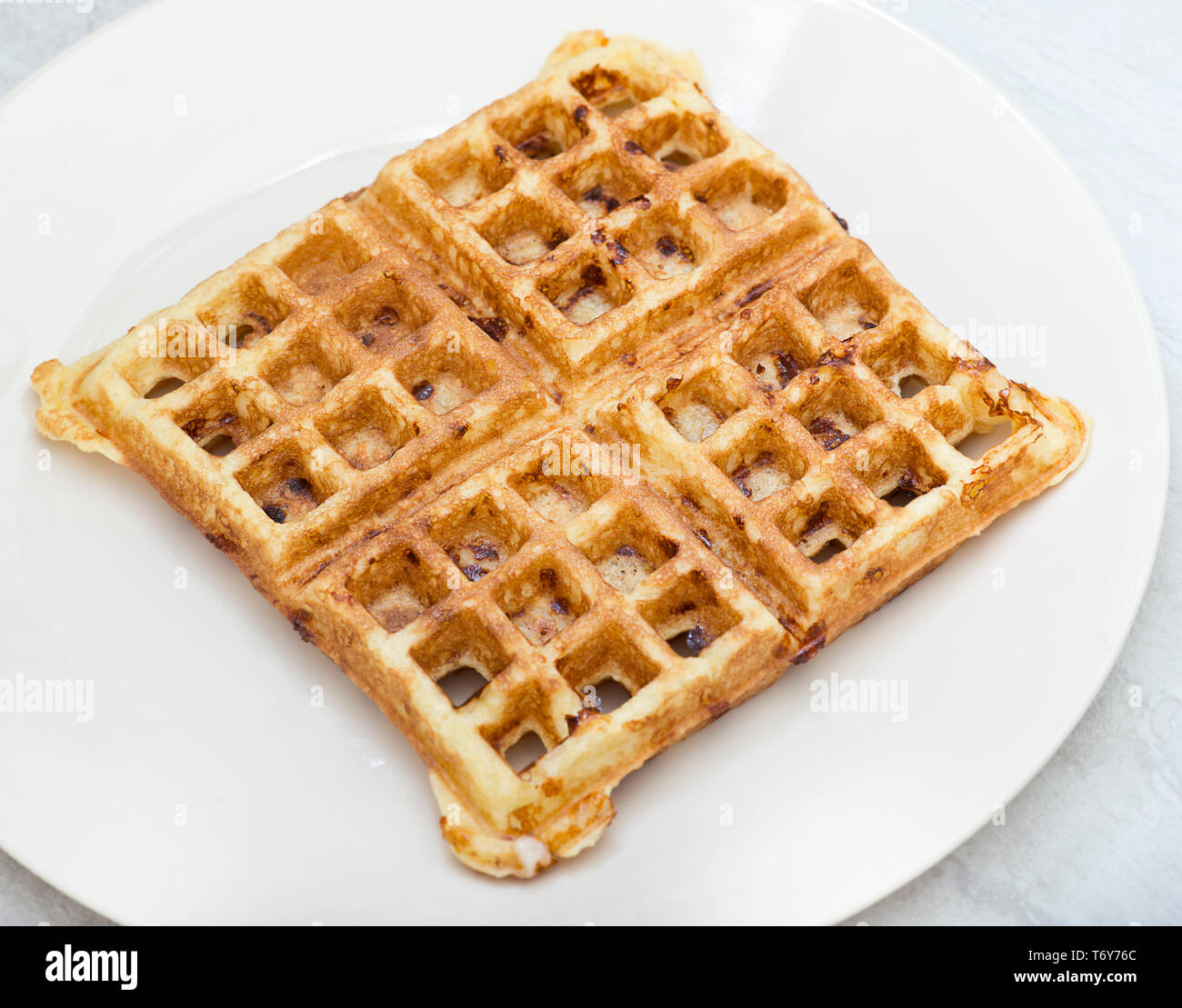 Homemade square belgian waffle on a white plate Stock Photo - Alamy