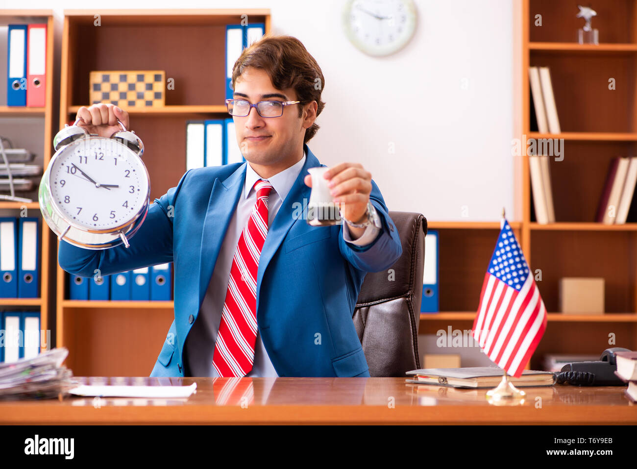Young handsome politician sitting in office Stock Photo - Alamy