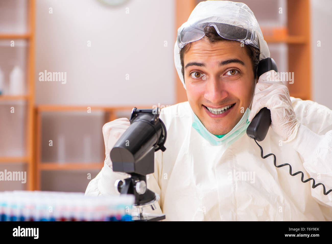 Young biochemist wearing protective suit working in the lab Stock Photo ...