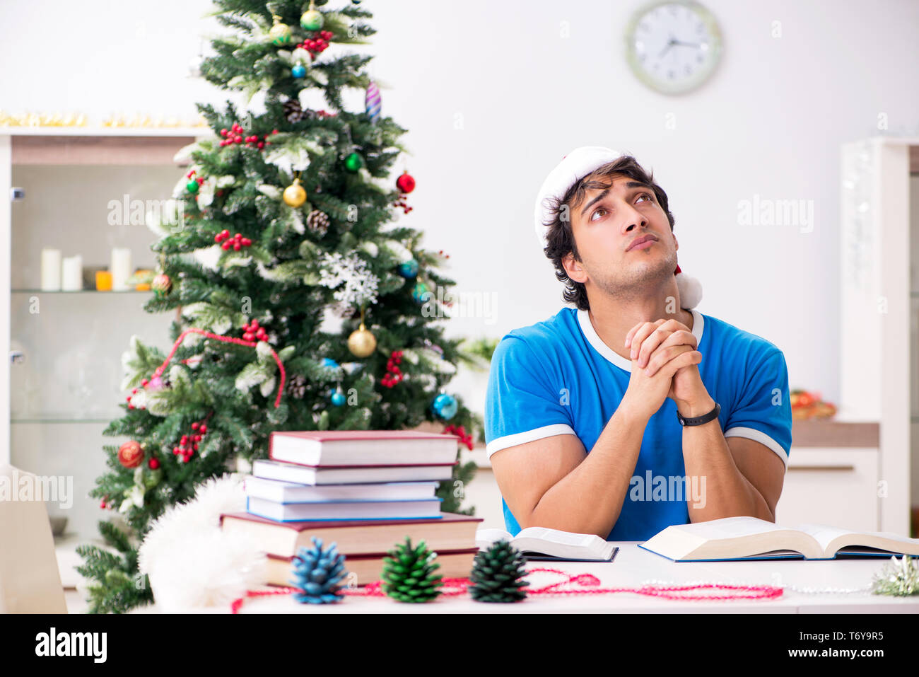Young student with book at Christmas eve Stock Photo - Alamy