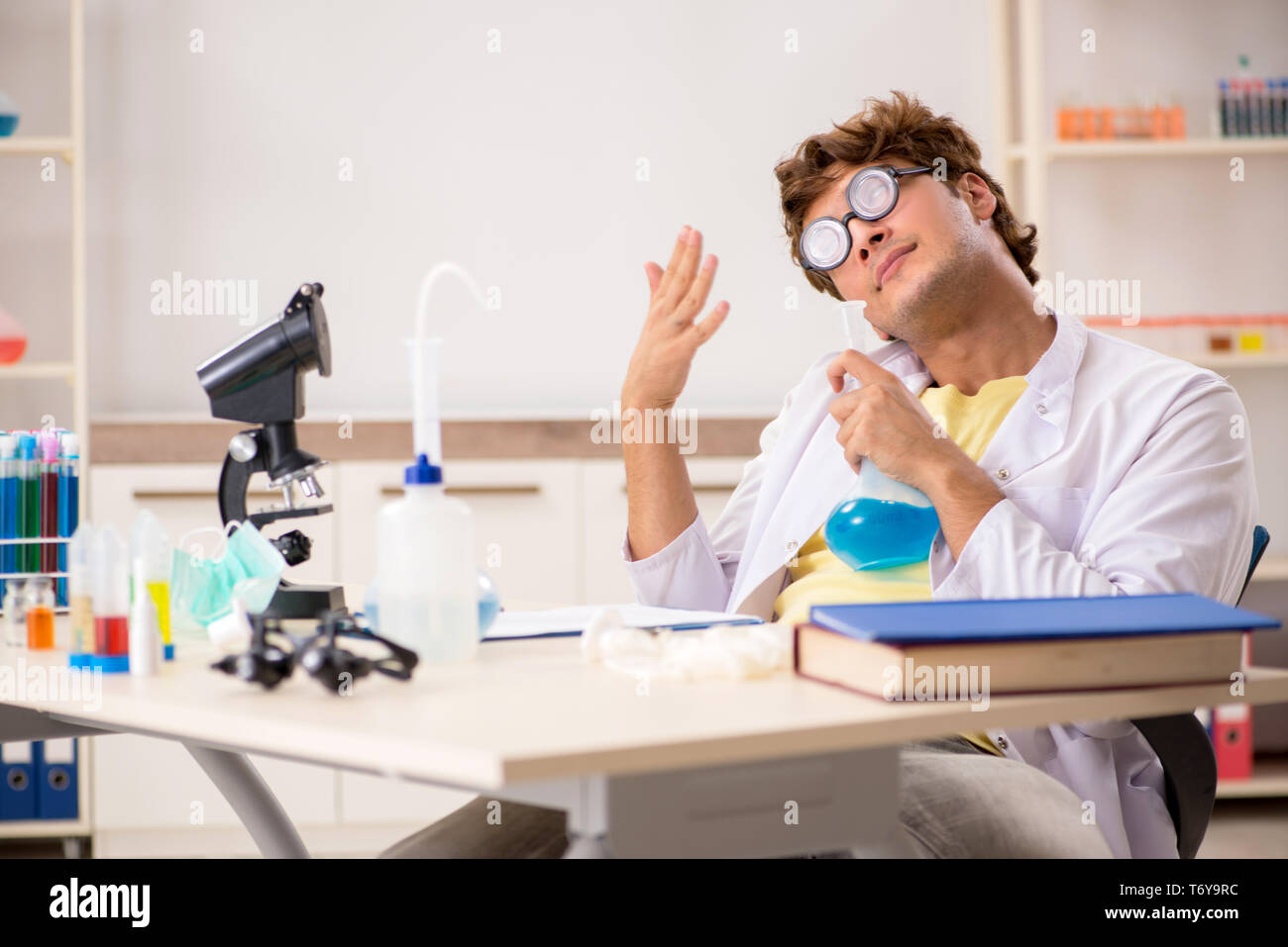 Funny crazy chemist doing experiments and tests Stock Photo - Alamy