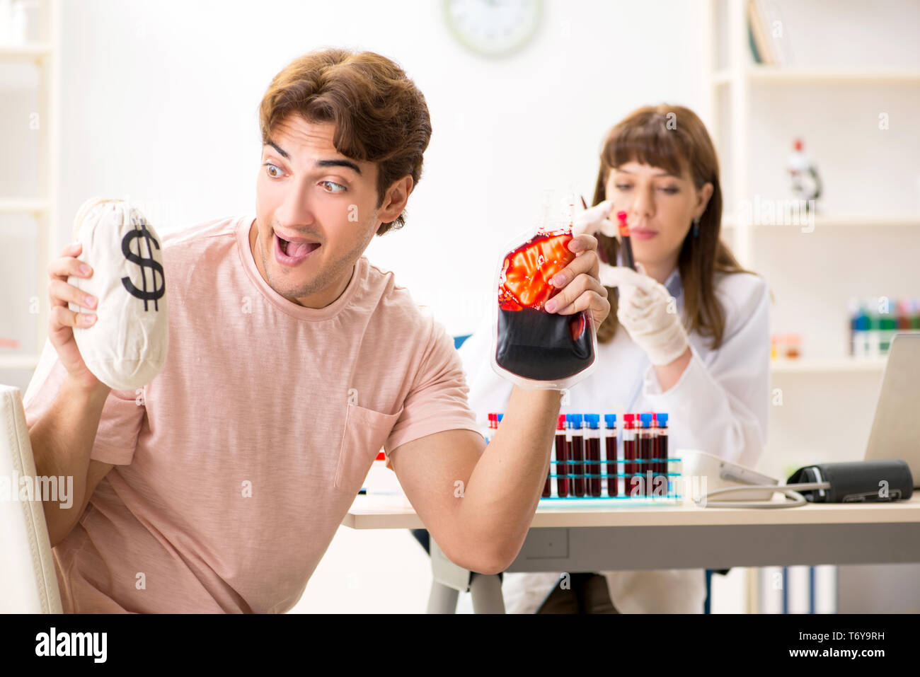Man giving his blood as a donor Stock Photo - Alamy