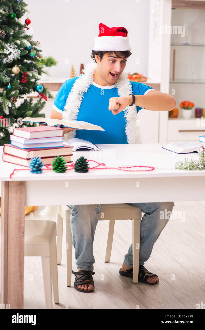 Young student with book at Christmas eve Stock Photo - Alamy