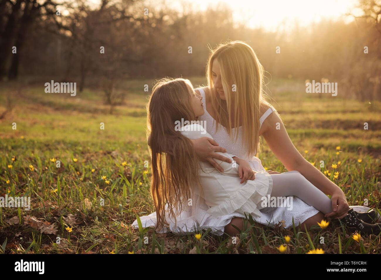 Loving single mother holds an upset daughter in tender embraces. Caring ...