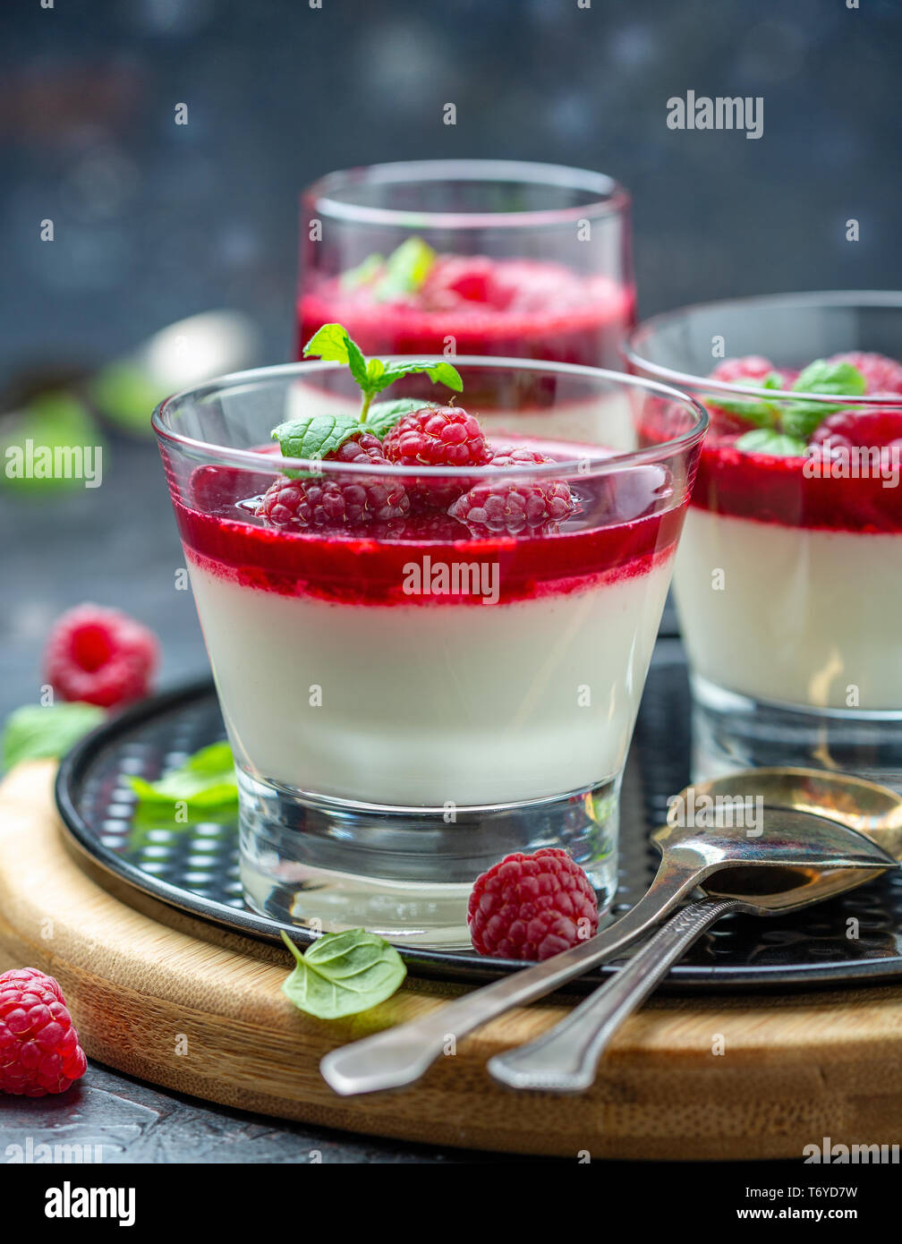 Vanilla Panna cotta with berry sauce and raspberry Stock Photo - Alamy