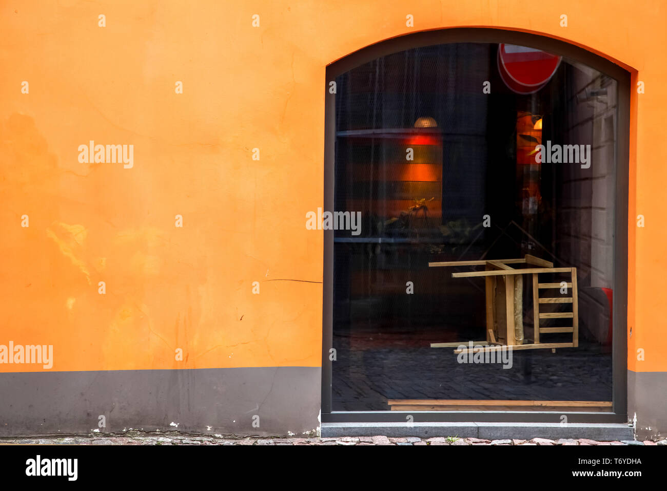 Orange wall with window in Riga Stock Photo - Alamy