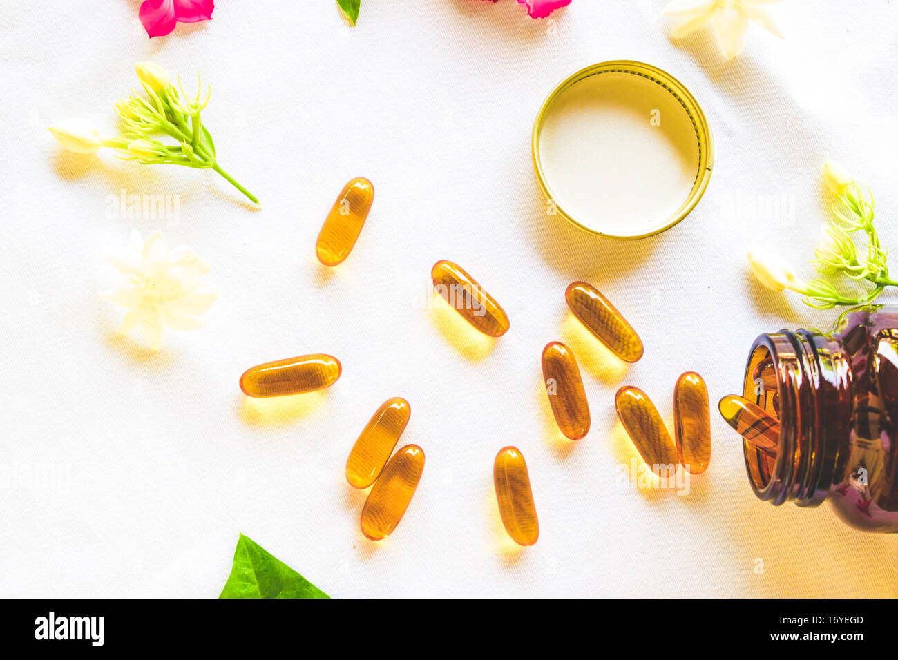 Omega 3 soft gel capsules are decorated with colored flowers over the ...