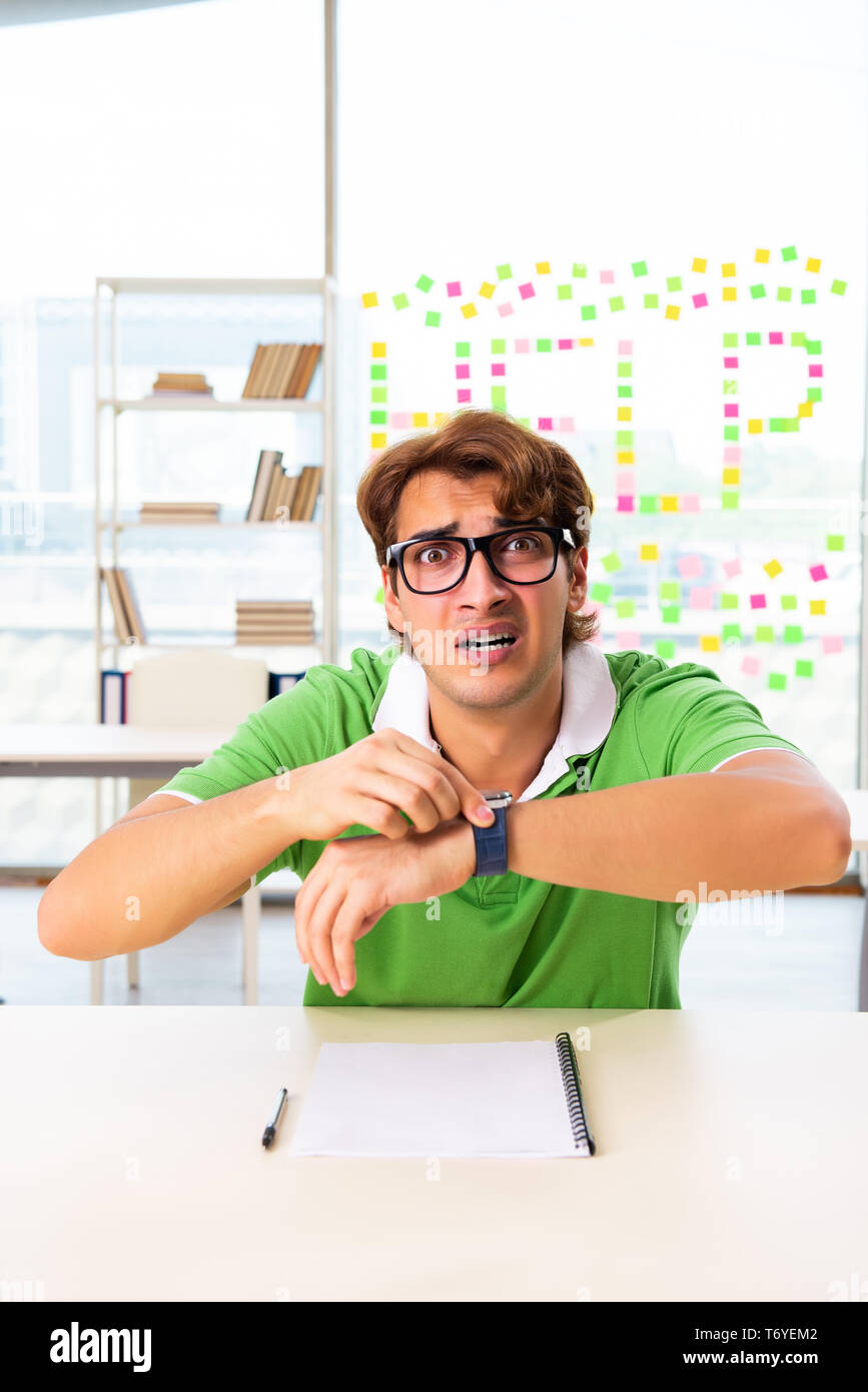 Student struggling at the exam in classroom Stock Photo - Alamy