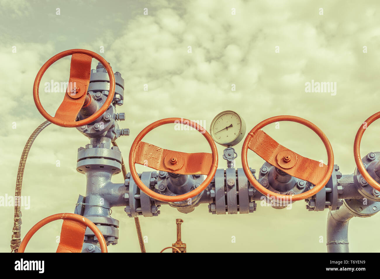 Wellheads with valve armature on a oil field Stock Photo - Alamy