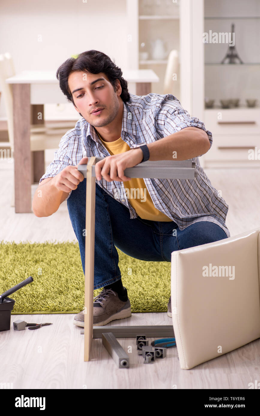 Young handsome man repairing hi-res stock photography and images - Alamy