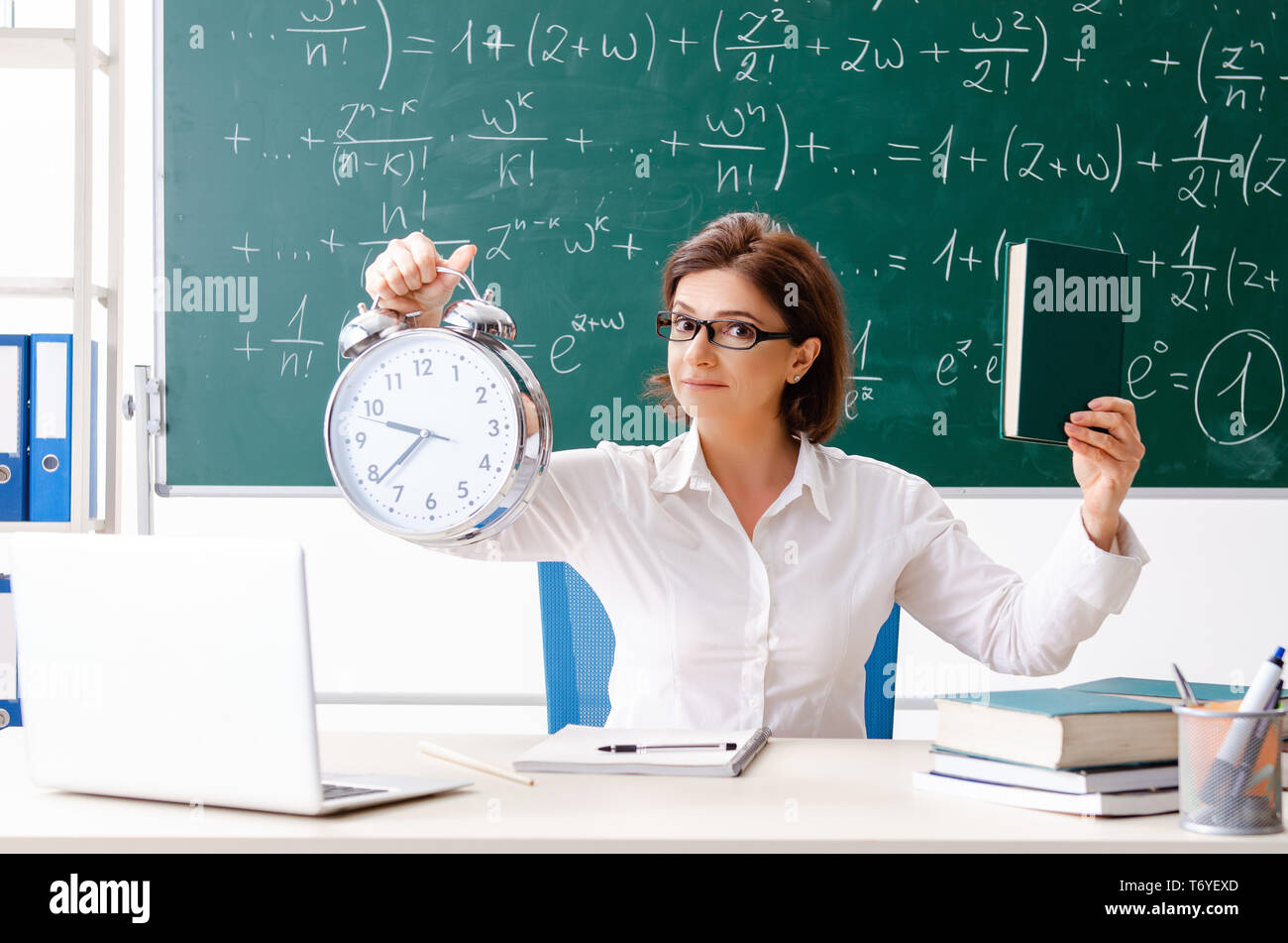 Female math teacher in front of the chalkboard Stock Photo - Alamy