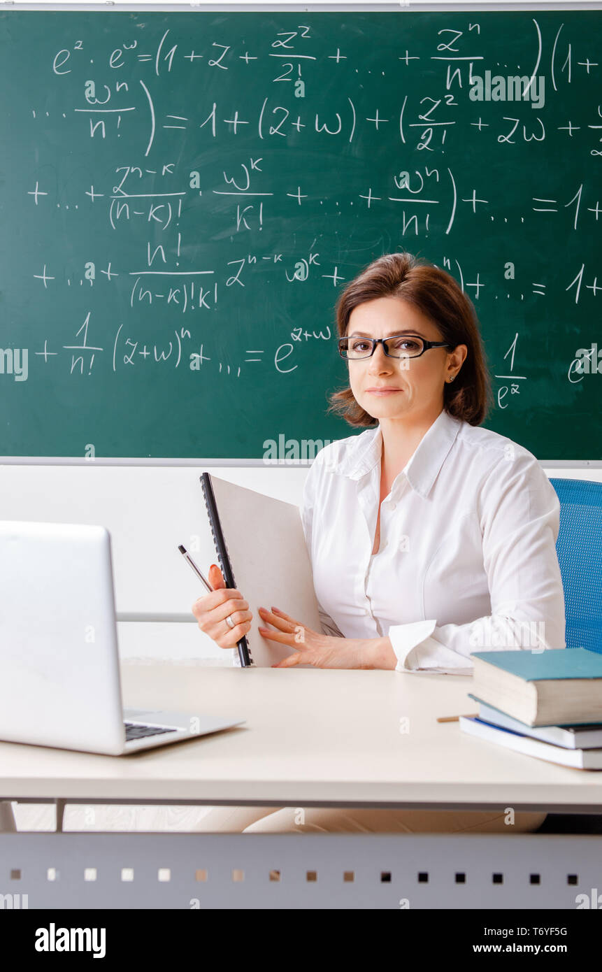 Female math teacher in front of the chalkboard Stock Photo - Alamy