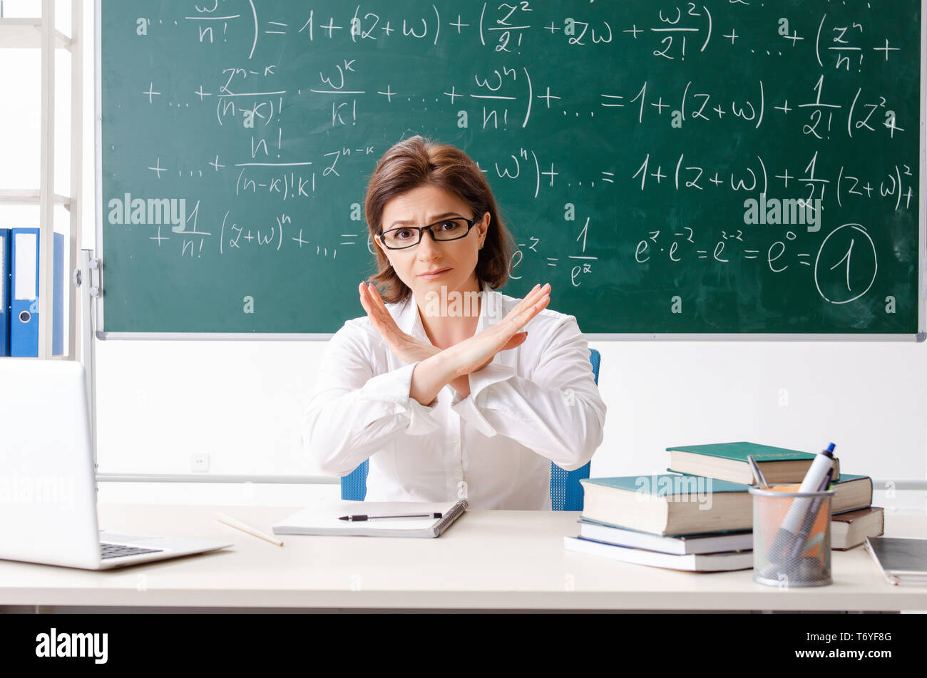 Female math teacher in front of the chalkboard Stock Photo - Alamy