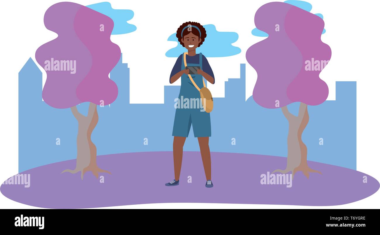 Millennial student afro woman wearing overalls using smartphone texting ...