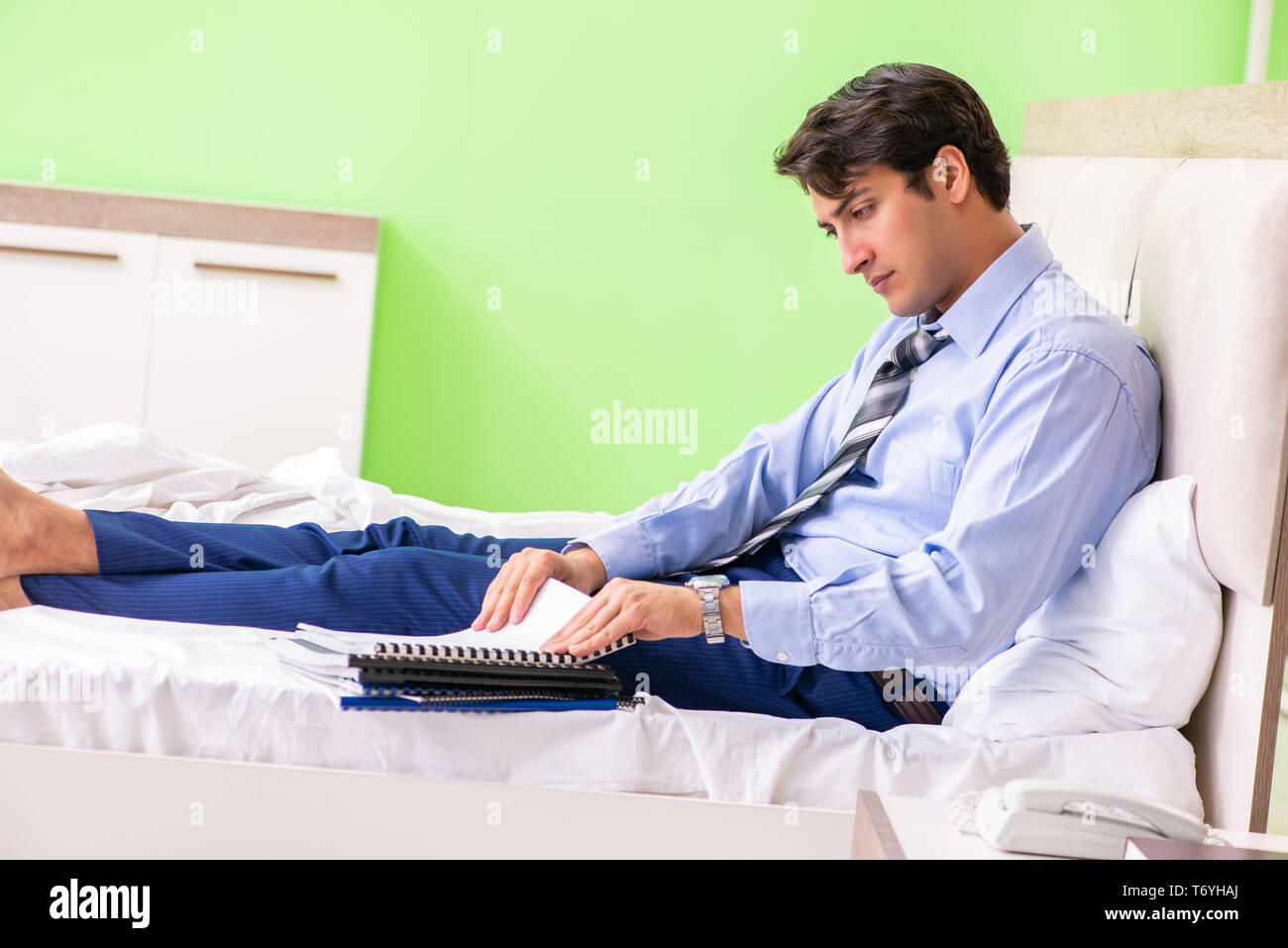 Businessman working overtime in hotel room Stock Photo - Alamy