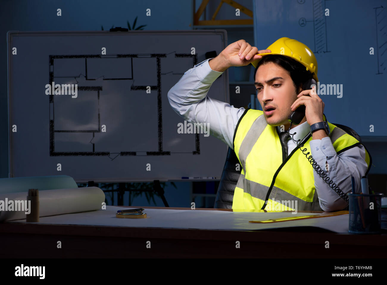 Young construction architect working on project at night Stock Photo ...