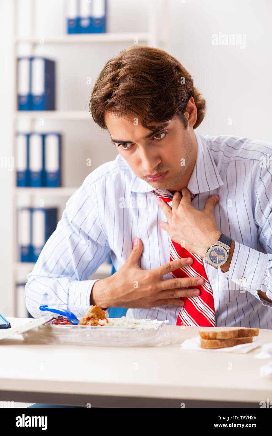Man having meal at work during break Stock Photo - Alamy