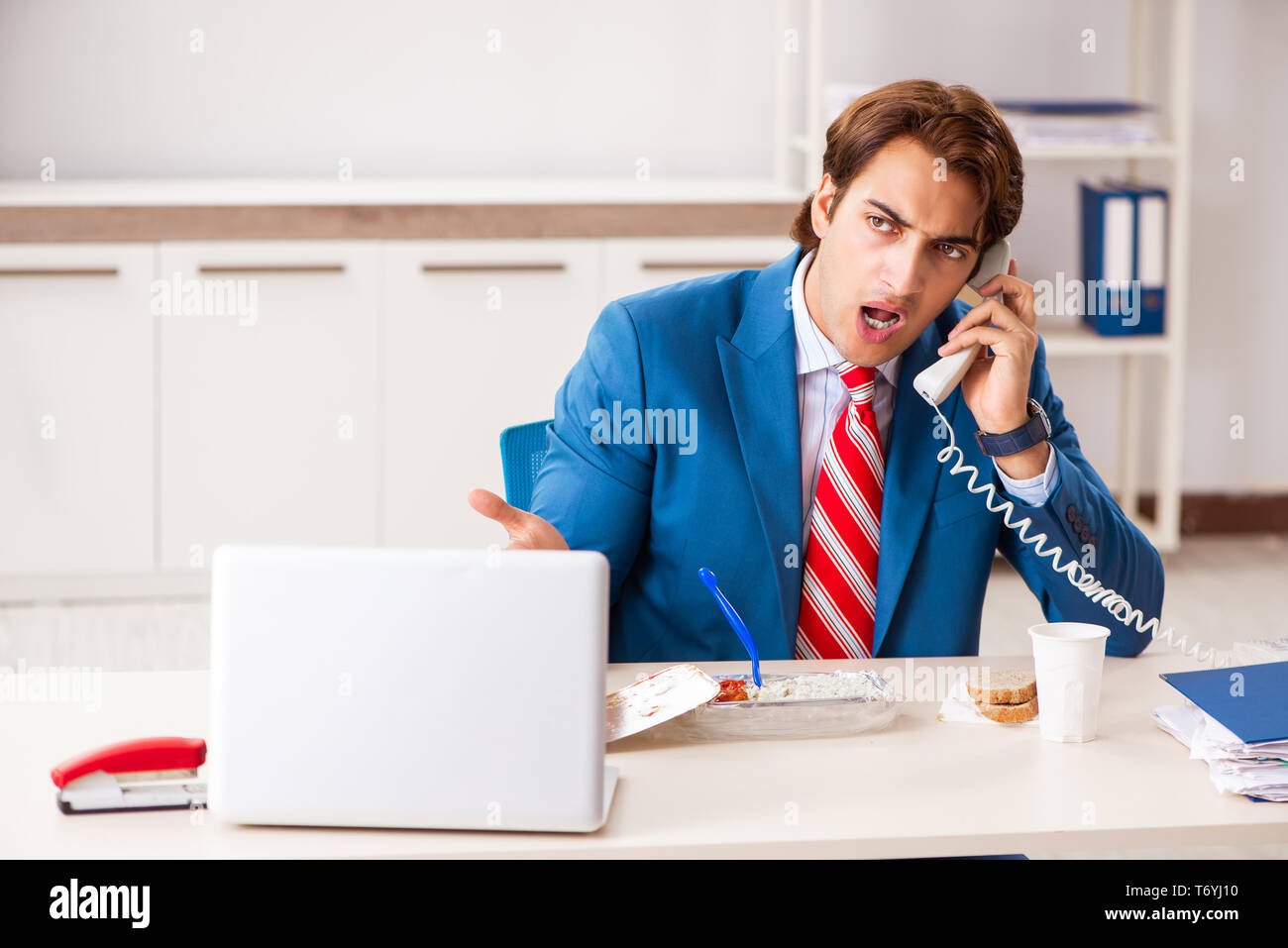 Man having meal at work during break Stock Photo - Alamy