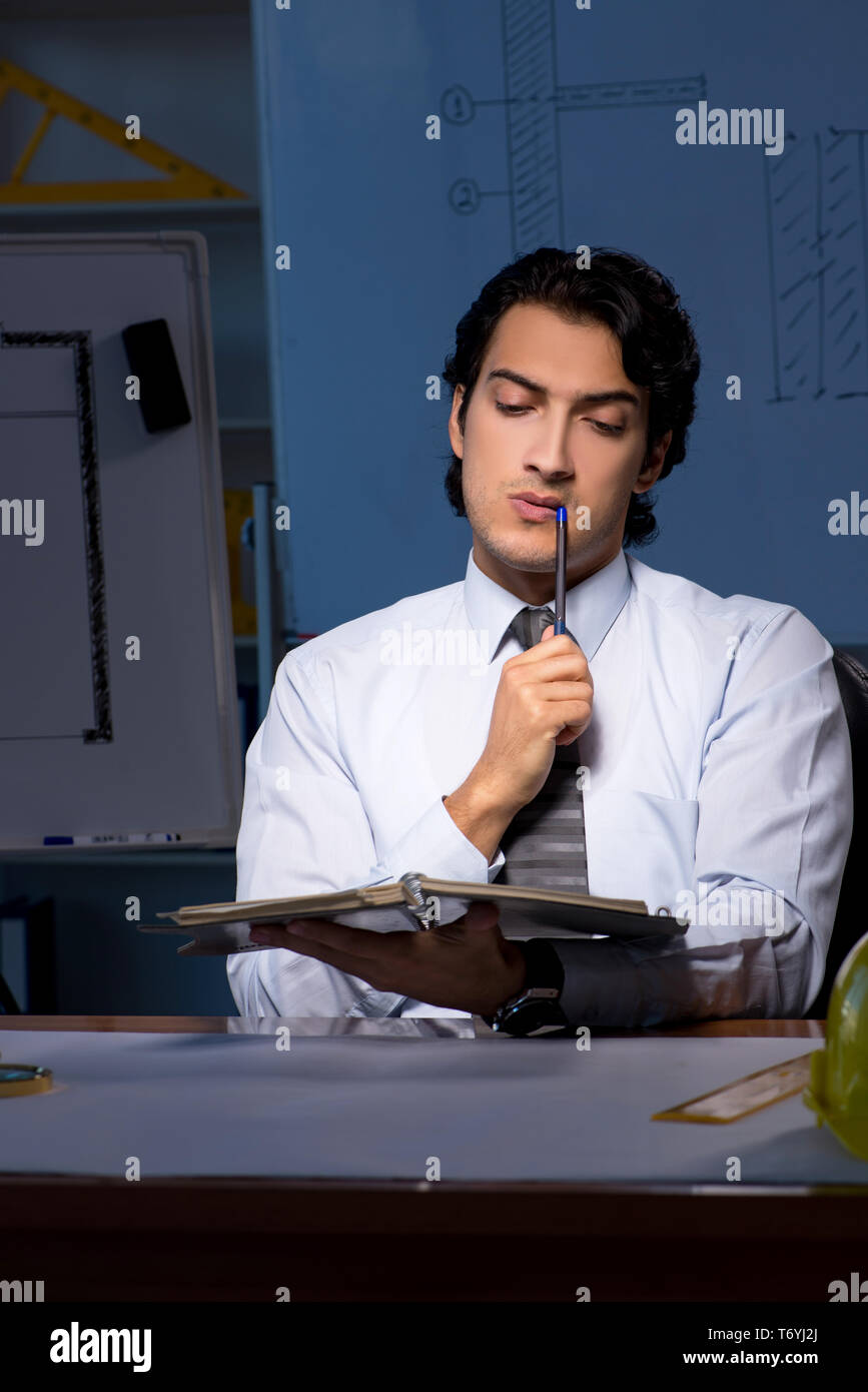 Young construction architect working on project at night Stock Photo ...