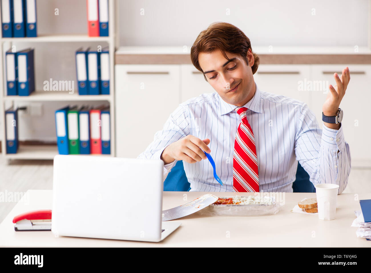 Man having meal at work during break Stock Photo - Alamy