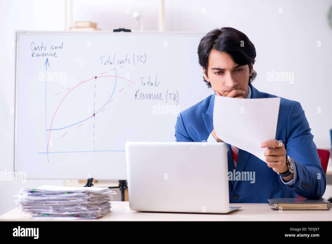 Busy businessman explaining business charts Stock Photo - Alamy