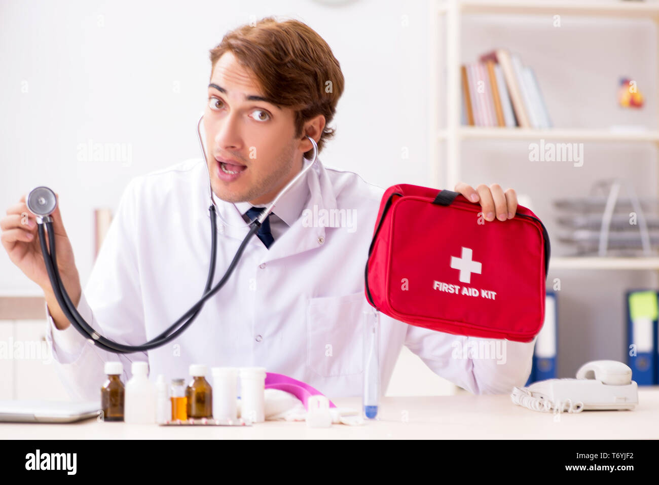 Young doctor with first aid kit in hospital Stock Photo - Alamy