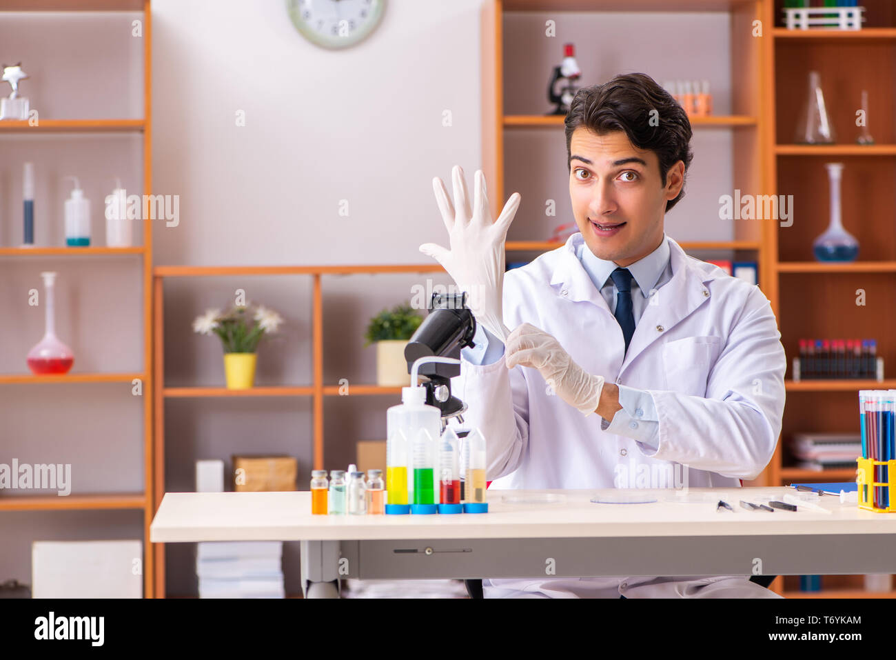 Young handsome biochemist working in the lab Stock Photo - Alamy