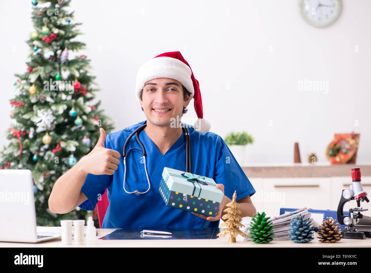 Doctor with gift box in the hospital Stock Photo - Alamy