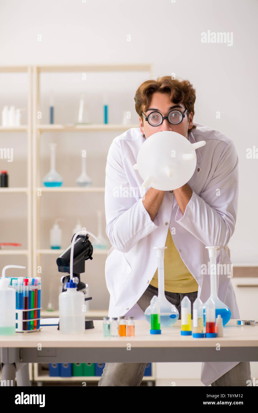 Funny crazy chemist doing experiments and tests Stock Photo - Alamy