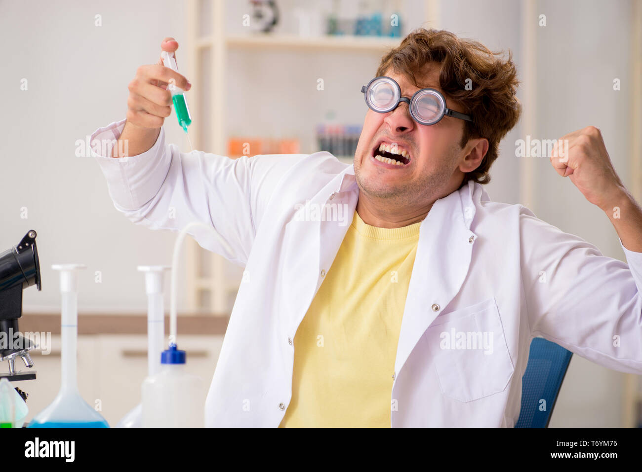 Funny crazy chemist doing experiments and tests Stock Photo - Alamy