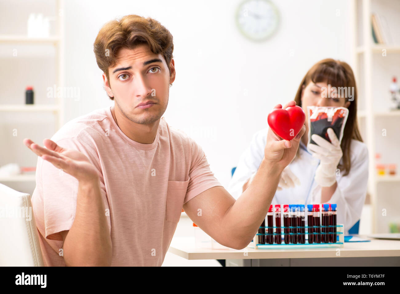 Man giving his blood as a donor Stock Photo - Alamy